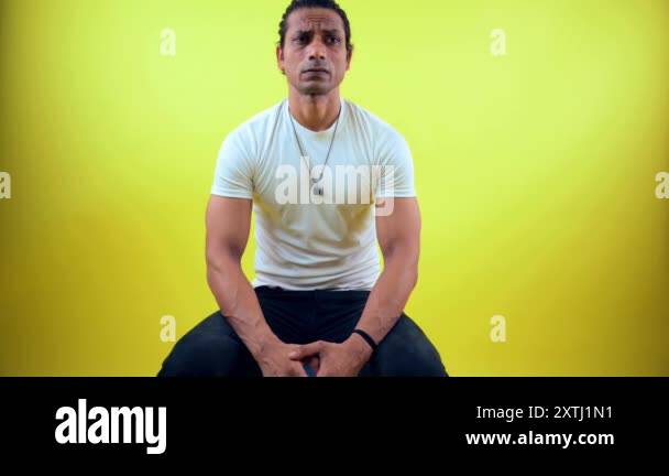 Confused man sitting on stool, Young person looking puzzled, seated ...