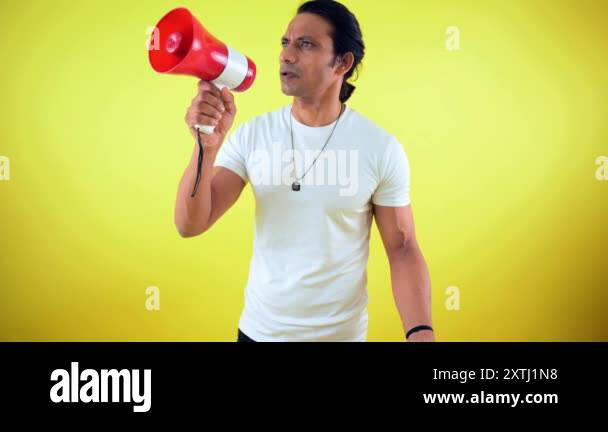 Man speaking through a megaphone, Young person shouting for sale, Male ...