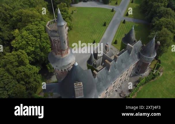 Explore the majestic Antoing Castle, its towers rising above the lush ...