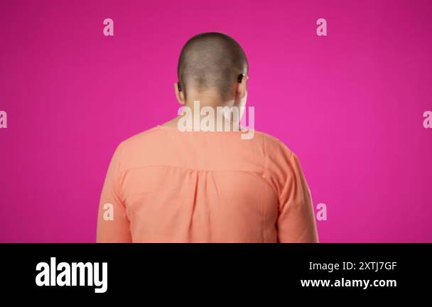 Pretty gender fluid non binary young woman 20s with hearing aid turns ...