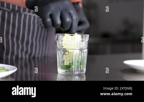 Add lemon to glass. Making lemonade, summer drink, cold drink, healthy ...