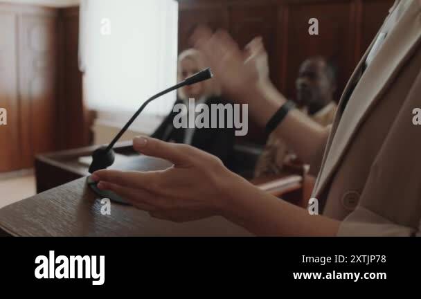 Close up view of hands of unrecognisable female witness in beige blazer ...