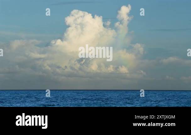On a sunny afternoon, towering cumulus clouds cast huge shadows across ...