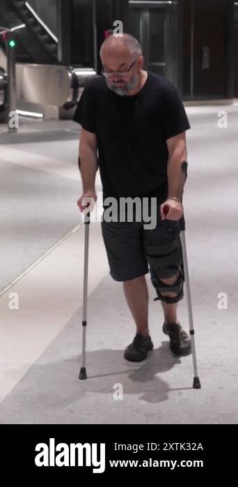 Mature man with bondage, medical splint, knee brace on the leg going to ...