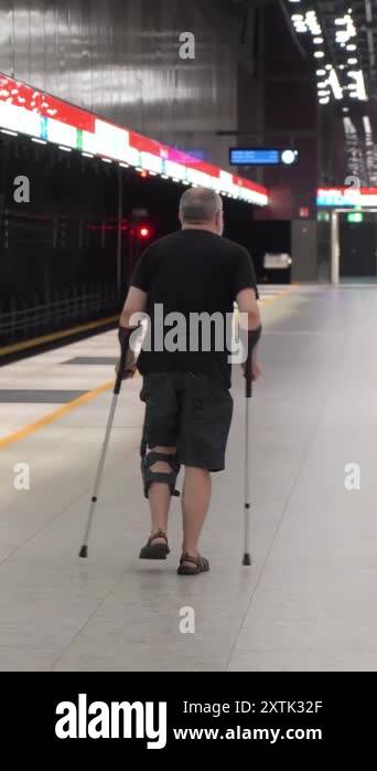Mature man with bondage, medical splint, knee brace on the leg going to ...