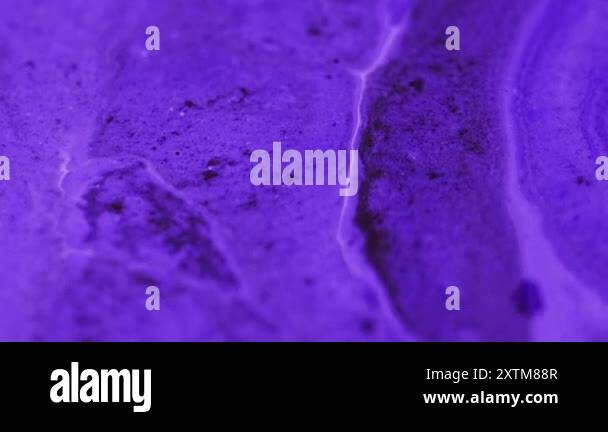 Acrylic fluid spill. Ink liquid wave. Defocused purple black color ...