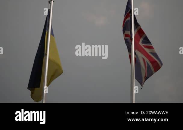 The national flags of Ukraine and Great Britain fly together, raised on ...