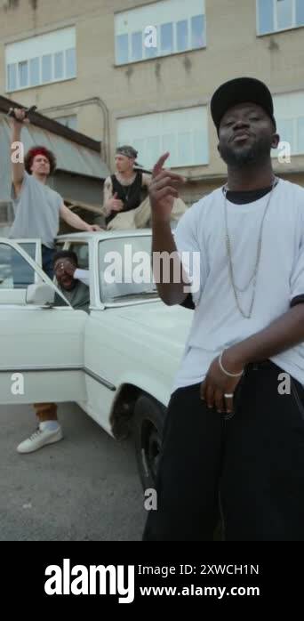Vertical shot of African American hip hop artist performing rap song on ...