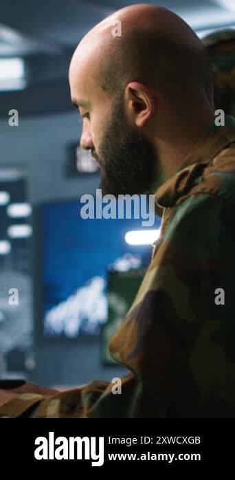 Vertical video Soldier doing tasks in military base, doing surveillance with digital radar ...