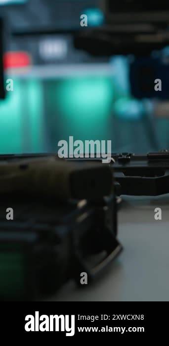 Vertical video Weapons on table in secure room in army governmental ...