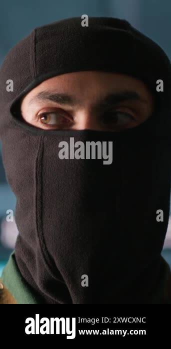 Vertical video Portrait of terrorist loading gun, attacking enemy ...