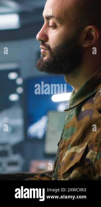Vertical video Soldier doing patriotic duty in military HQ base, gathering information on enemy ...