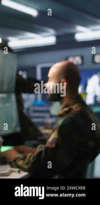 Vertical video Special forces professional in military HQ base gathering information on enemy ...