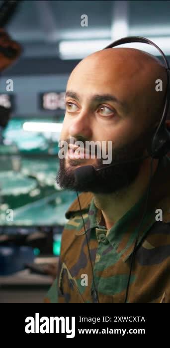 Vertical video Middle Eastern military dispatcher relays info from army intelligence analysts to ...