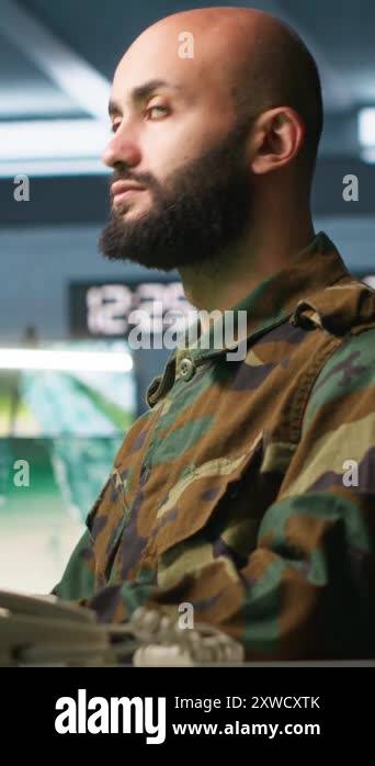 Vertical video Special forces professional in military HQ base gathering information on enemy ...