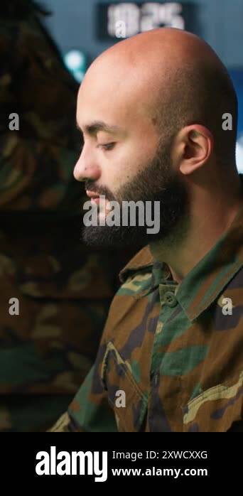 Vertical video Military officers checking weapons in control room, ensuring bullets and supplies ...