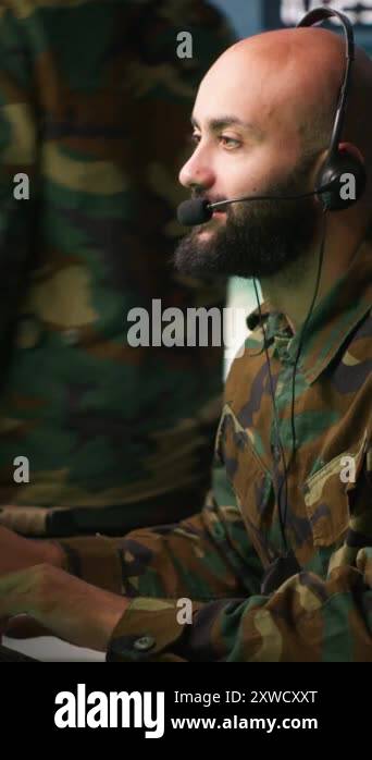 Vertical video Soldier solving tasks in military HQ base, gathering information on enemy troops ...