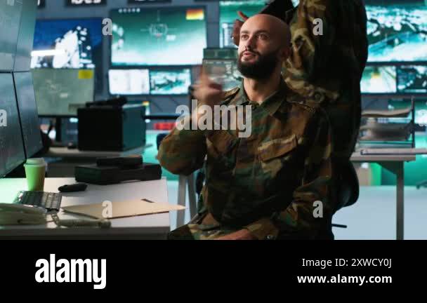 Military agent using augmented reality tech in control room, analyzing ...
