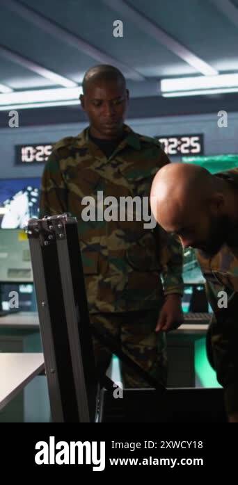 Vertical video Army soldiers packing weapons able to engage targets at ...