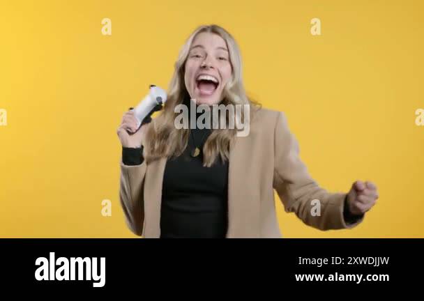 Pretty young businesswoman playing video exciting game on Tv with ...