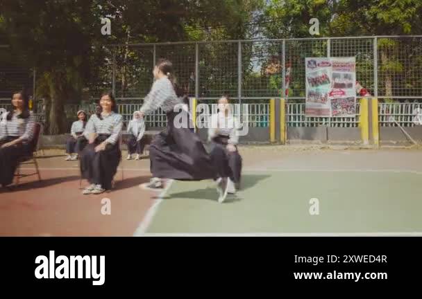 Students in uniforms participating in an outdoor activity involving ...