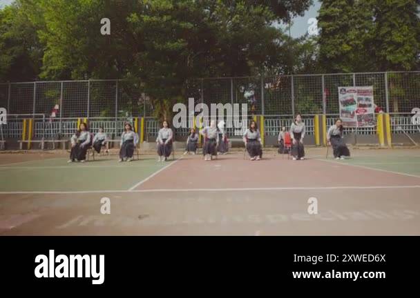 A group of dancers in traditional attire performing a choreographed ...