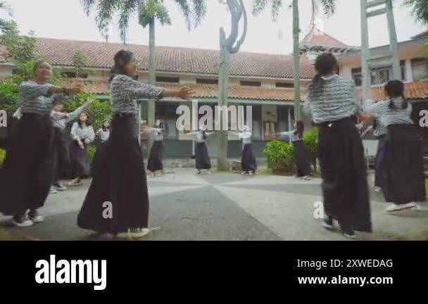 A group of young people performing a synchronized dance routine on a ...