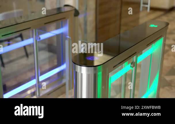 Confident businesswoman effortlessly passes through a modern turnstile ...