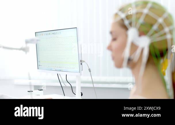 Young woman undergoes an EEG test in a modern clinic, showcasing ...