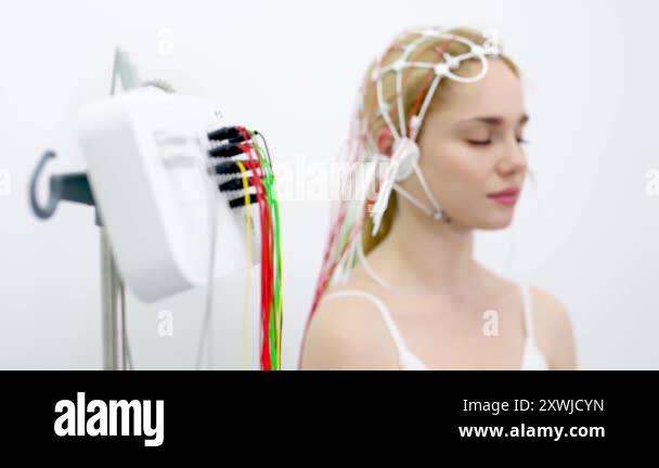 Young Woman Undergoes An Eeg Test In A Modern Clinic Showcasing