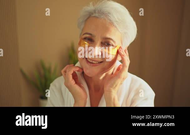 Eye patch beauty aging treatment. Mature adult old woman with under eye ...