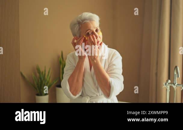 Eye patch beauty aging treatment. Mature adult old woman with under eye ...
