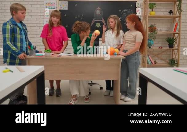 Group of primary school kids learning science in class. Junior school ...