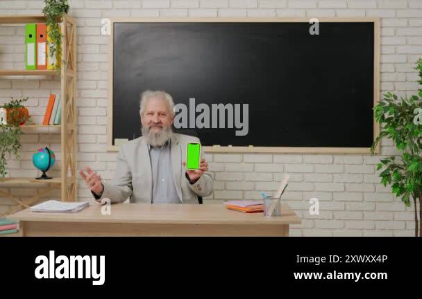School teacher in auditorium during lesson. Aged man college professor ...