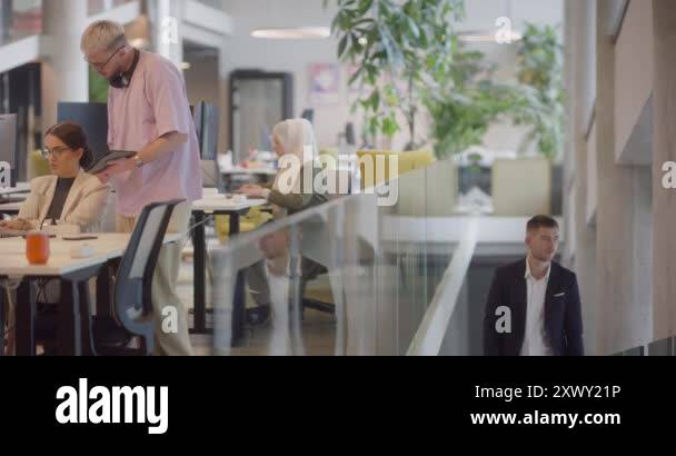 A director arrives at a large, modern office, where he joins his ...