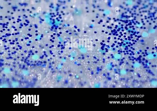 Sparkling fluid. Liquid glitter flow. Defocused blue color shiny sequin ...
