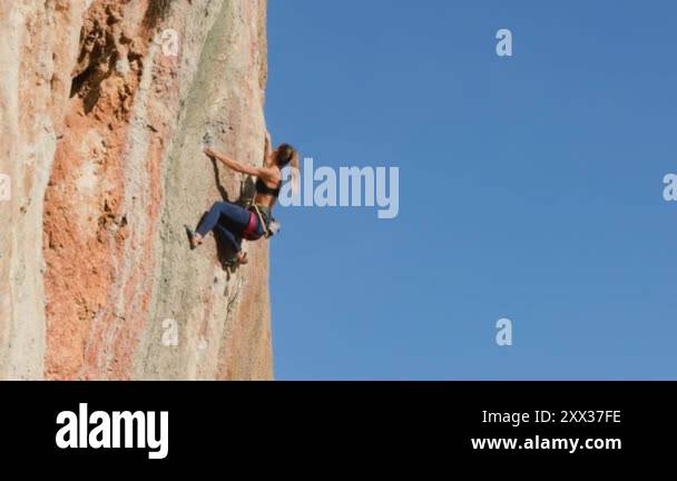 A girl climbs a rock. A woman plays sports in nature. A climber is ...