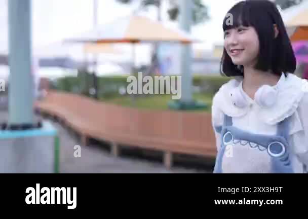 In Shilin District, Taipei City, Taiwanese woman in her twenties on date, strolling and ...