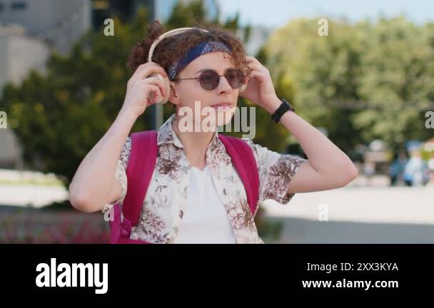 Portrait of happy smiling Caucasian young man listening music taking ...