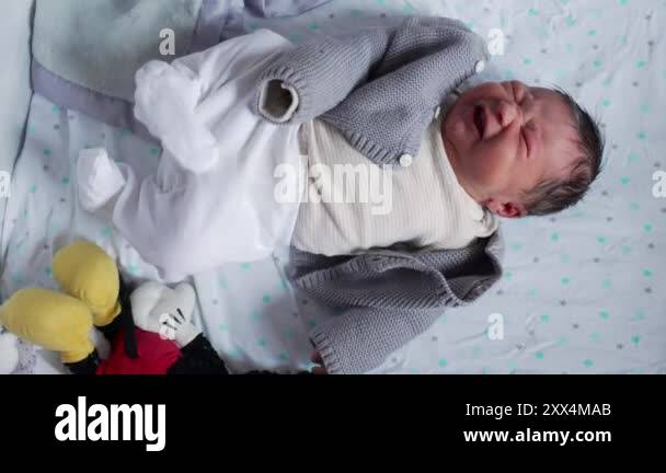 Newborn baby stretching and crying, showcasing the raw emotions and ...