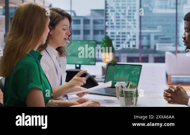 Applicant gives his CV to human resources staff to begin the job interview, reviewing the ...