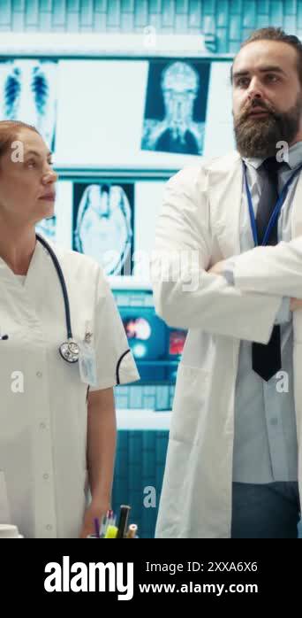 Vertical Video Doctor specialists reviewing human anatomy scans via ...