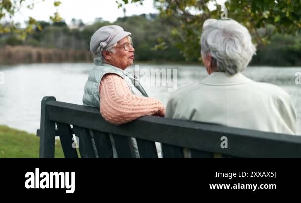 Elderly, women and friends with conversation on park bench, talking and ...