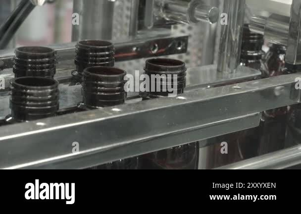 Bottles filling automation machine in modern factory. Technology ...