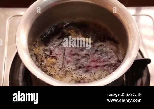 Making red tea, or rong cha in a silver pot on a gas stove. This ...