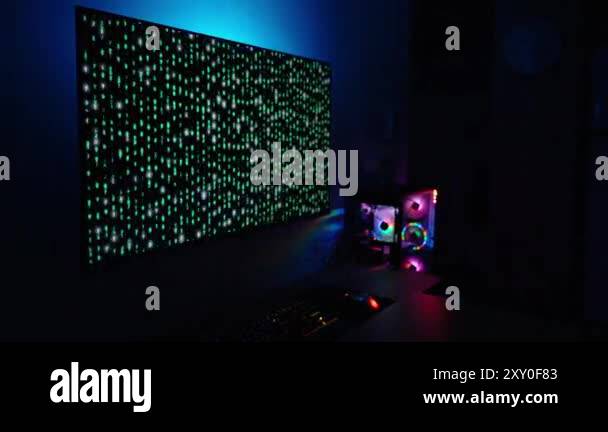 Computer Setup in a Dark Room, Monitor Displaying Green Matrix Code ...