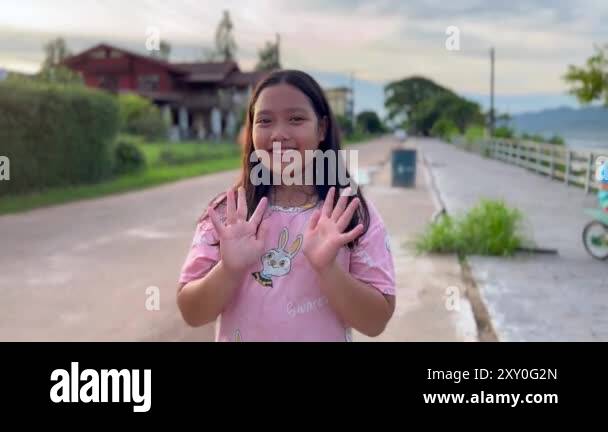 child waving goodbye and smiling, A heartwarming video of a little girl ...