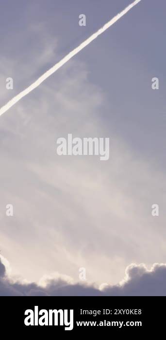 Large passenger supersonic plane flying high in clear blue sky, leaving ...
