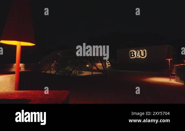 A modern architectural structure at night, featuring a glass dome and ...