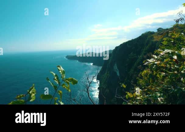 A breathtaking coastal view showcasing steep cliffs meeting the ocean ...